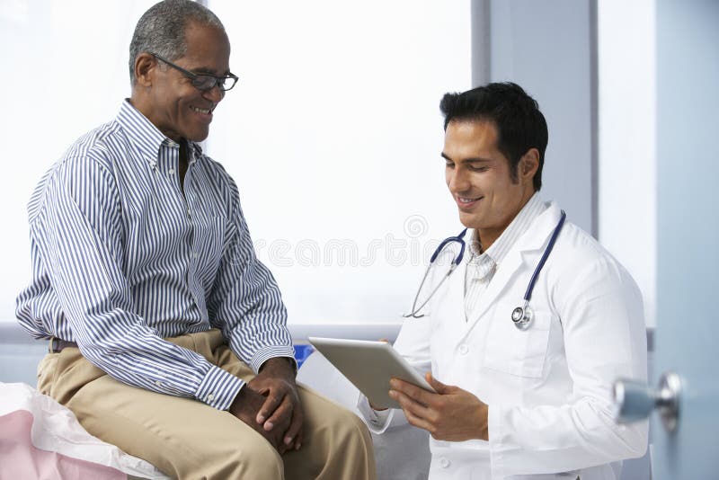 Doctor in Surgery with Male Patient Using Digital Tablet Stock Photo ...