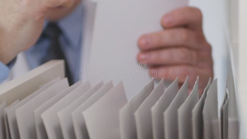 Doctor Take a Document from Medical Archive Drawer and Write Some ...