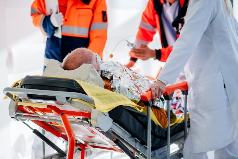 Doctor Taking Care of Patient from Rescue Ambulance. Stock Image ...