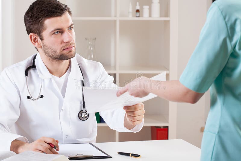 Doctor Taking Documents from a Nurse Stock Image - Image of laboratory ...