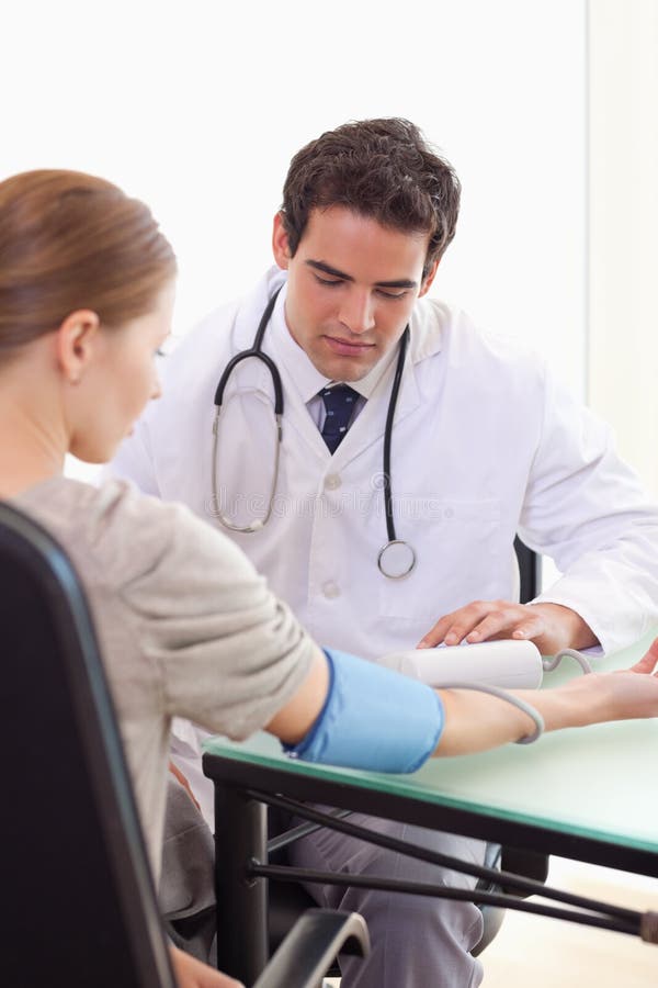 Doctor Taking His Patients Blood Pressure Stock Photo - Image of ...