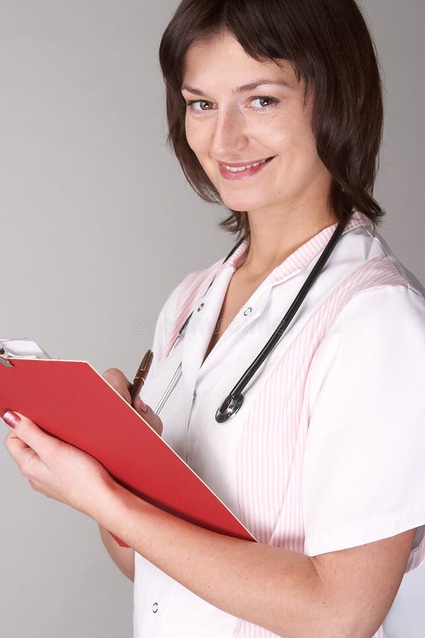 Doctor taking notes stock photo. Image of brunette, personal - 1719376