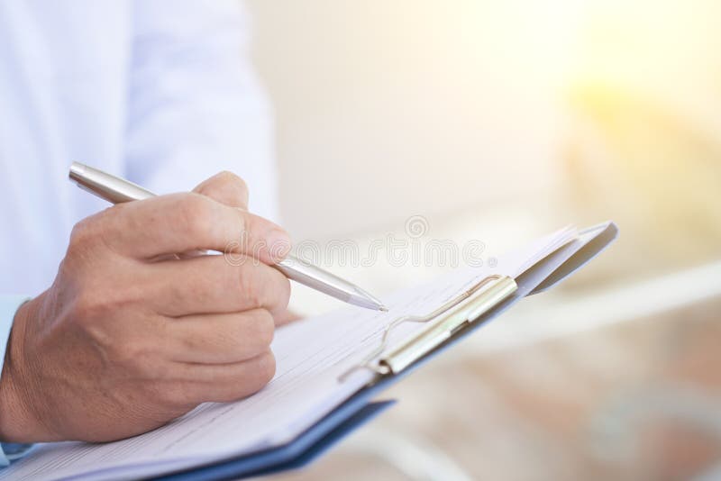 Doctor taking notes stock image. Image of doctor, hospital - 129793999
