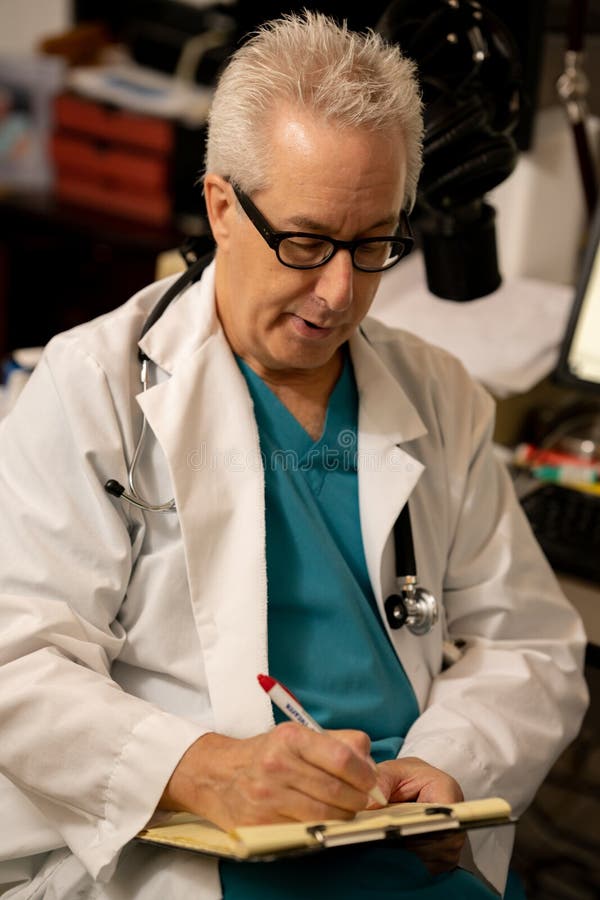 Doctor Taking Notes on a Paper Pad in His Office Stock Image - Image of ...