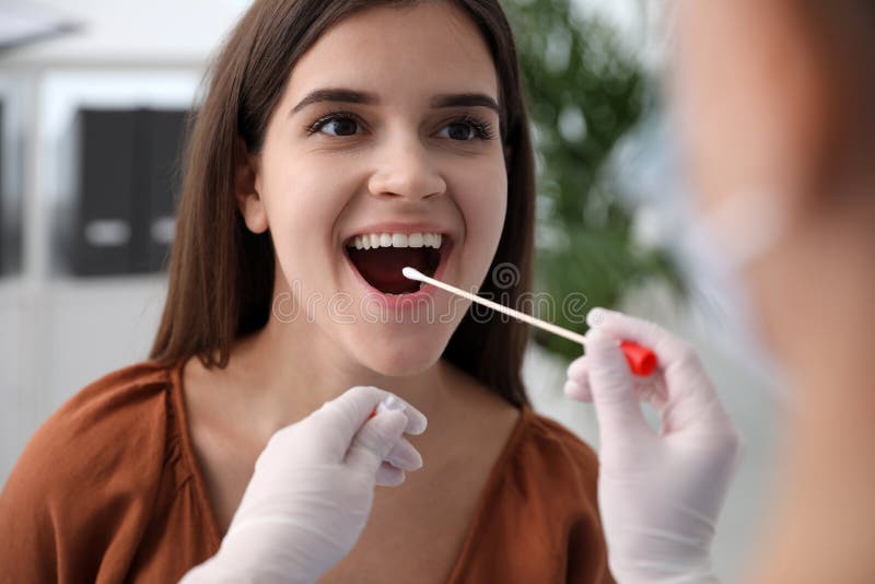 Doctor Taking Sample for DNA Test from Woman in Clinic Stock Image ...