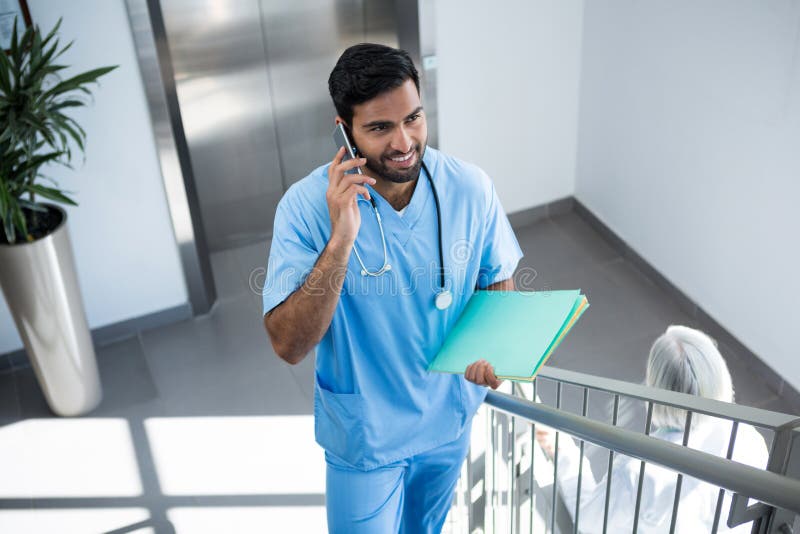 Doctor Talking on Mobile Phone while Standing on Staircase Stock Image ...