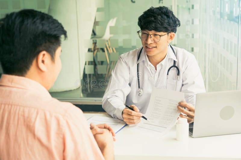 Doctor Talking Patient History List on Note Pad and Talking To the ...