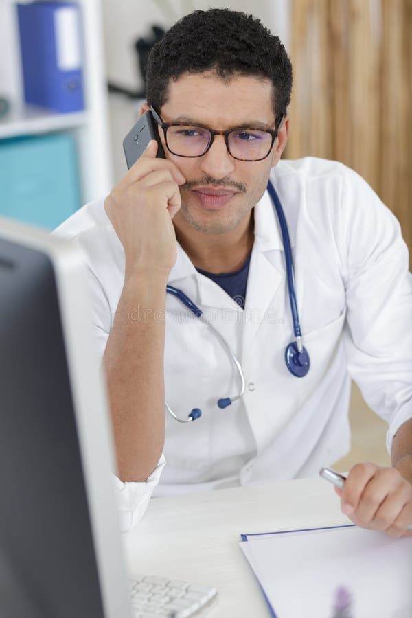 Doctor talking on phone stock image. Image of medical - 245861085