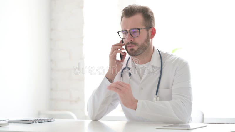 Doctor Talking on Phone in Clinic Stock Image - Image of smiling ...