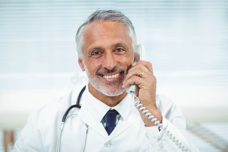 Doctor talking on phone stock image. Image of confidence - 67532365