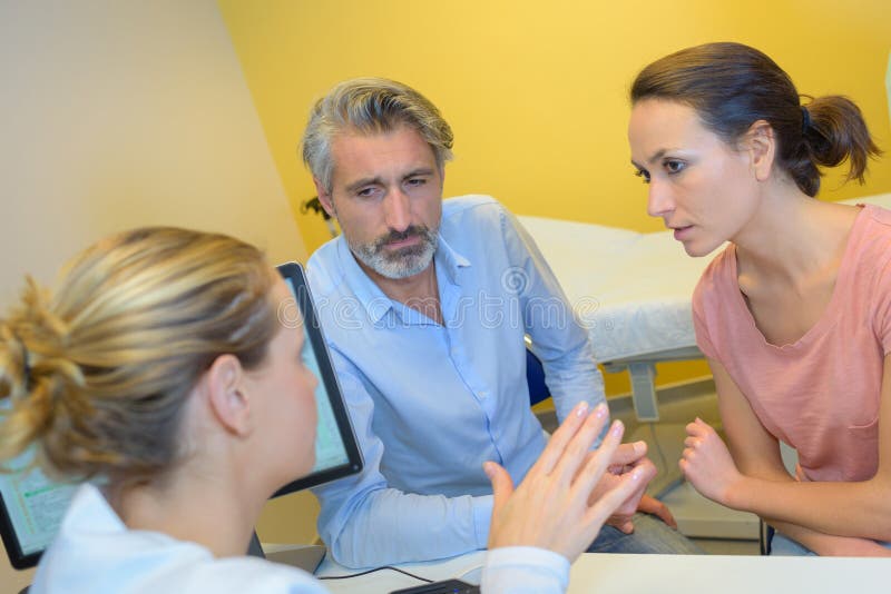 Doctor Talking Seriously To Middle Aged Couple Stock Image - Image of ...