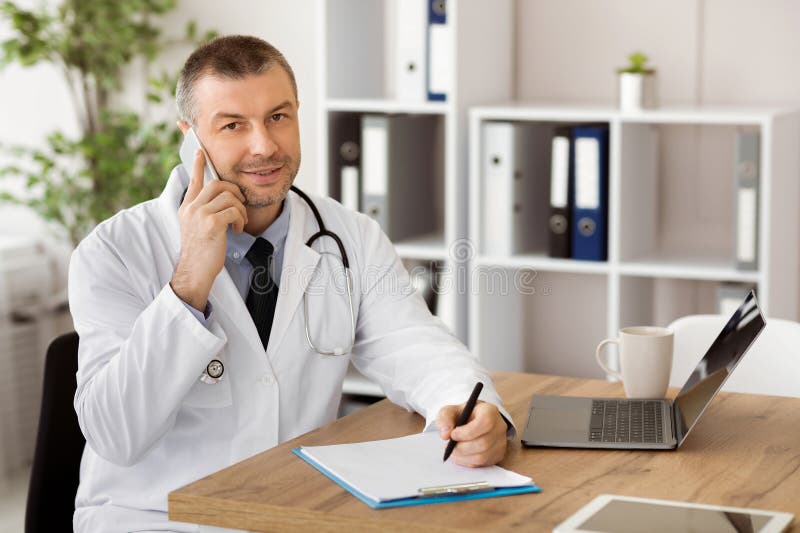 Doctor Talking Smart Phone Patient Writing Notes Stock Photos - Free ...