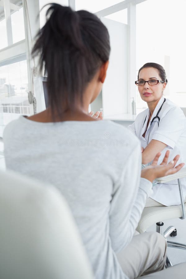Doctor Talking To Her Patient Stock Photo - Image of people, indoors ...