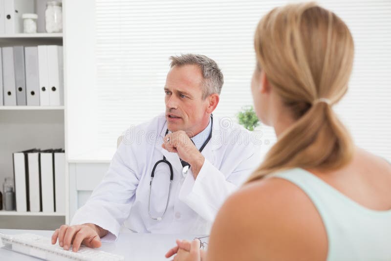 Doctor Talking To His Patient Stock Image - Image of mature, examining ...