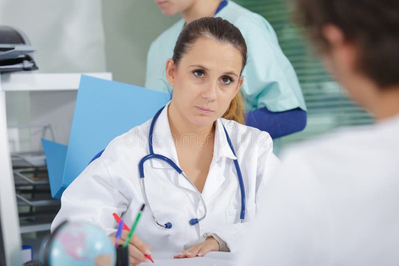 Doctor Talking To Patient and Taking Notes Stock Image - Image of ...