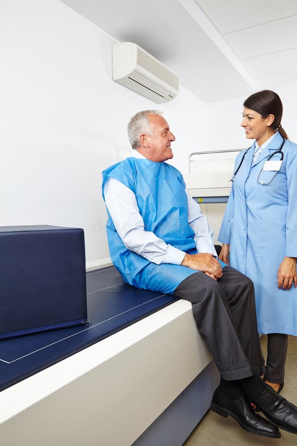 Doctor Talking To Senior before Bone Density Measurement Stock Image ...