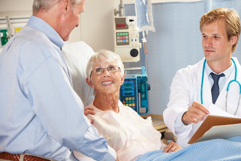 Doctor Talking To Senior Couple on Ward Stock Image - Image of female ...