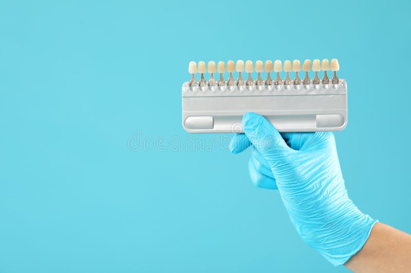 Doctor with Teeth Color Chart on Light Blue Background, Closeup and ...