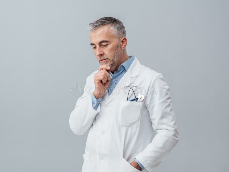 Doctor Thinking with Hand on Chin Stock Image - Image of mature ...