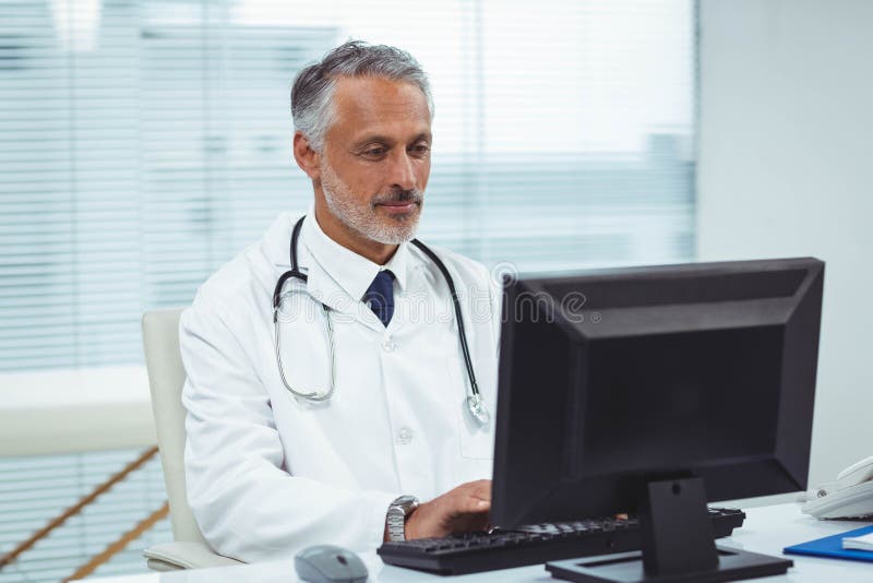 Male Doctor or Nurse Seated with Laptop Computer Stock Image - Image of ...