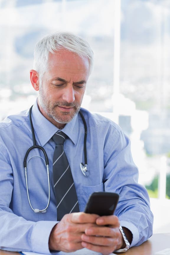 Doctor Typing a Text Message on His Smartphone Stock Photo - Image of ...
