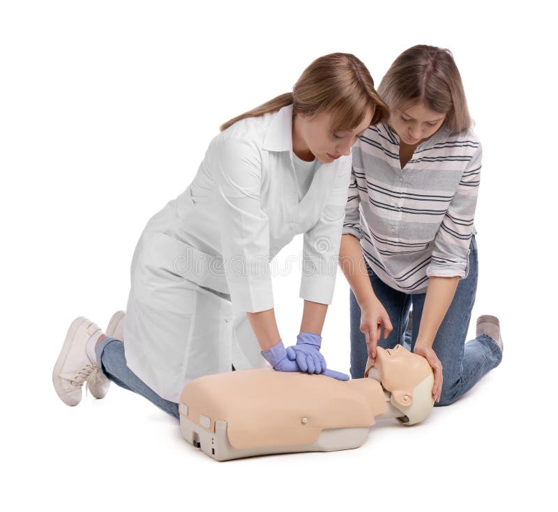 Doctor in Uniform Demonstrating First Aid on Mannequin Against White ...