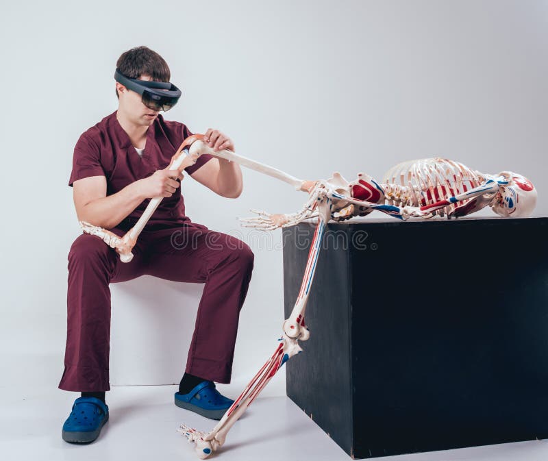 Doctor Uses Augmented Reality Goggles To Exam Human Skeleton. Stock ...