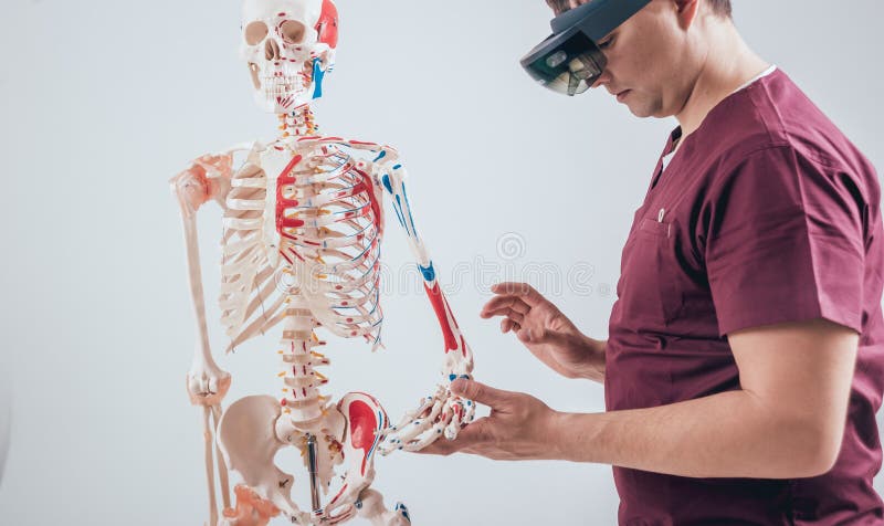 Doctor Uses Augmented Reality Goggles To Exam Human Skeleton. Stock ...