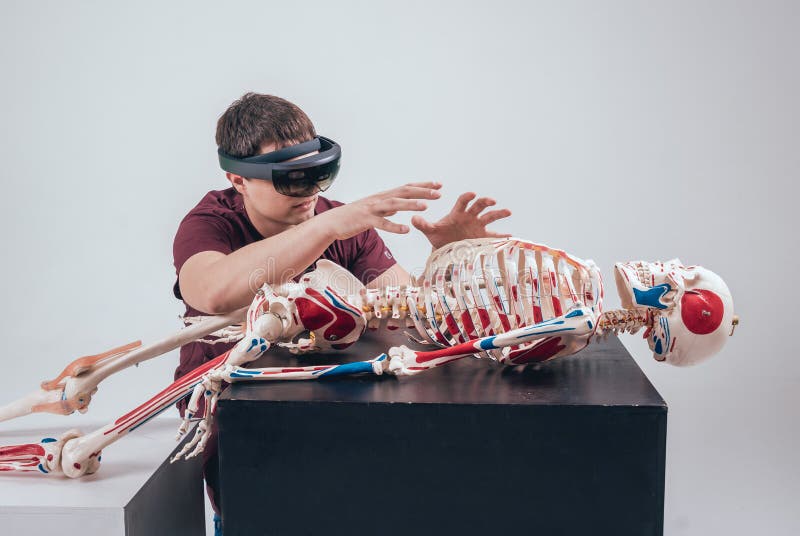 Doctor Uses Augmented Reality Goggles To Exam Human Skeleton. Stock ...