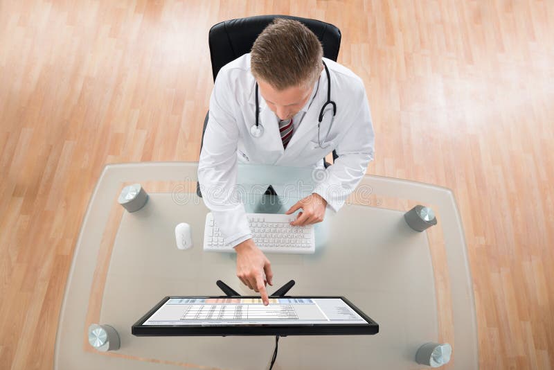 Doctor Using Computer at Desk Stock Photo - Image of gesture, floor ...