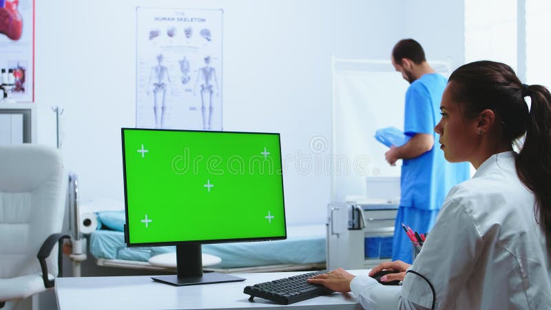 Doctor Using Computer with Green Screen Display Stock Image - Image of ...