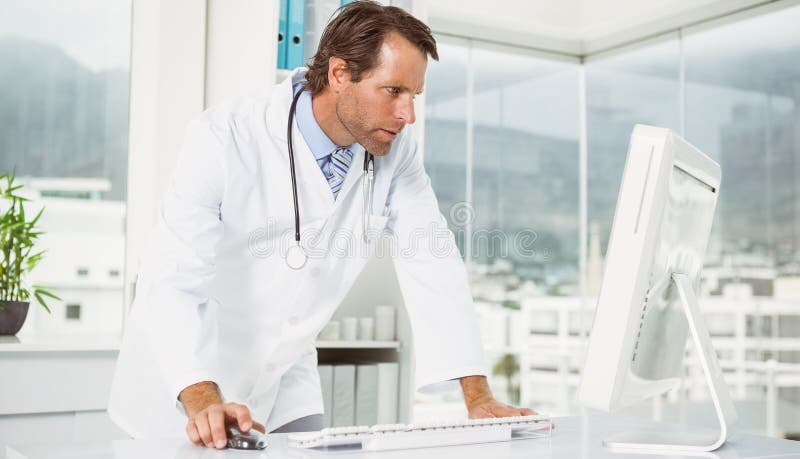 Doctor Using Computer at Medical Office Stock Photo - Image of indoors ...