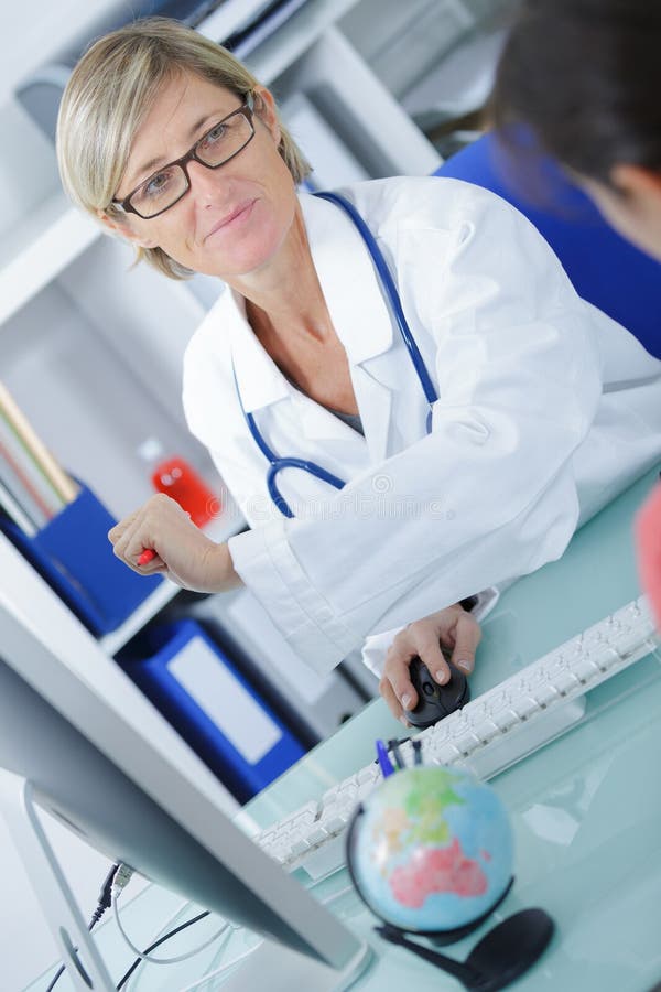 Doctor Using Computer and Smiling at Patient Stock Image - Image of ...