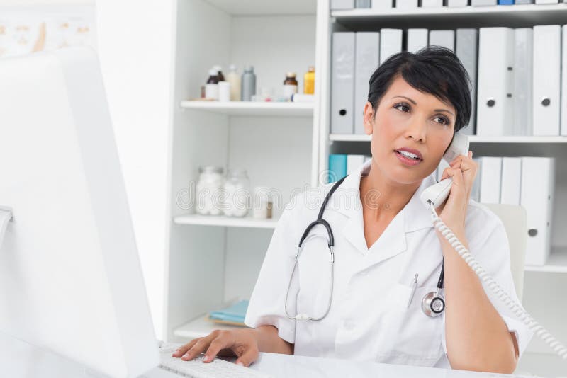 Doctor Using Computer and Telephone Stock Photo - Image of care ...