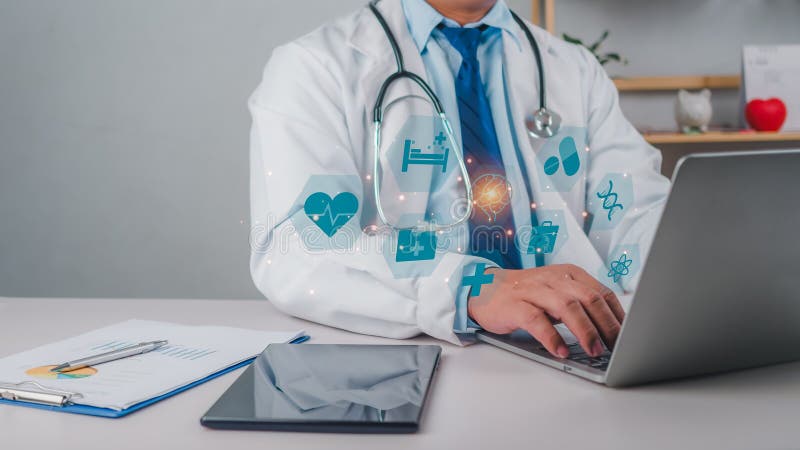 A Doctor Using Computer To Review Treatment Plan and Write Document ... A Doctor Using Computer To Review Treatment Plan and Write Document ...