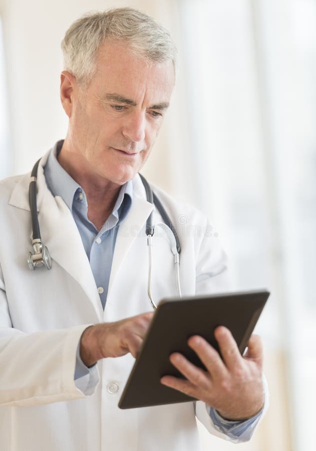 Doctor Using Digital Tablet at Clinic Stock Photo - Image of holding ...