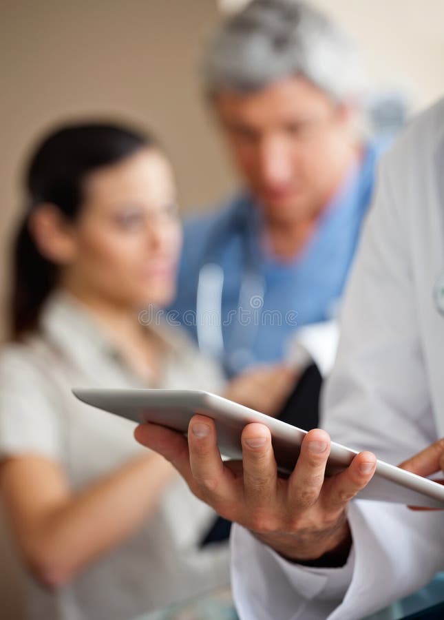 Doctor in Clinic Reading Digital File on Tablet Computer Stock Photo ...