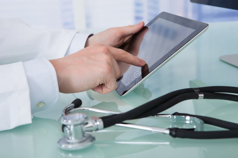 Doctor in Clinic Reading Digital File on Tablet Computer Stock Photo ...