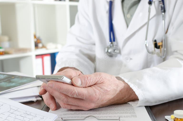 Doctor Using His Smartphone Stock Image - Image of doctor, table: 57022875
