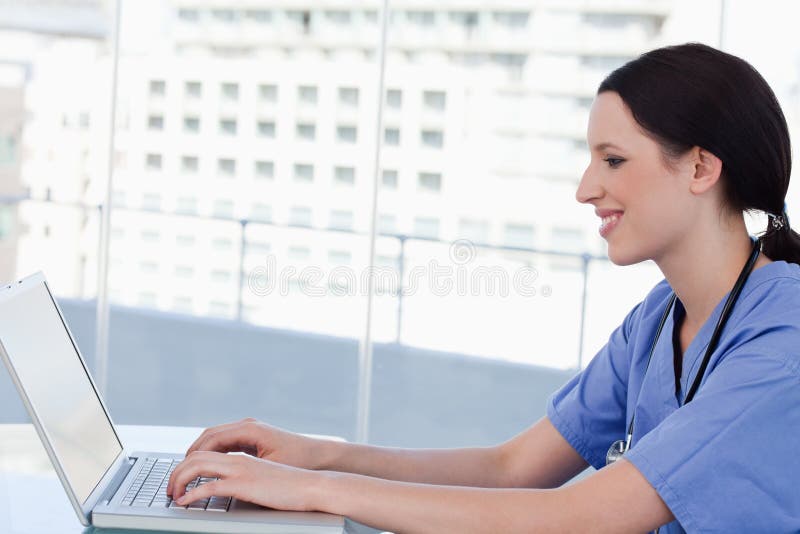 Doctor using a laptop stock image. Image of hand, indoors - 22692749