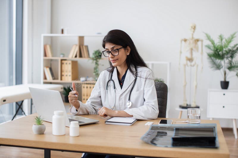 Doctor Using Laptop for Video Call with Patient at Hospital Stock Image ...
