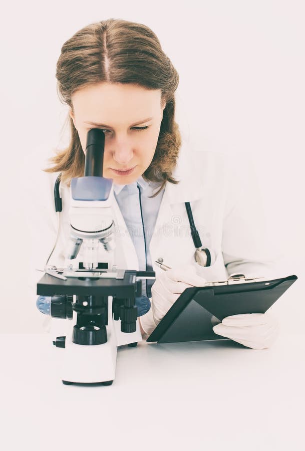 Doctor using microscope. stock image. Image of biology - 93677581