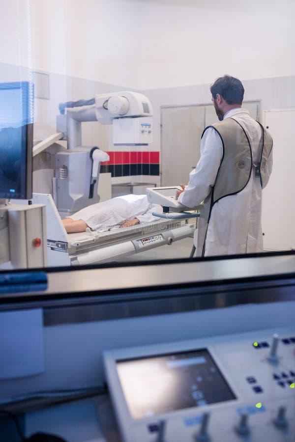 Doctor Using X-ray Machine To Examine Patient Stock Photo - Image of ...
