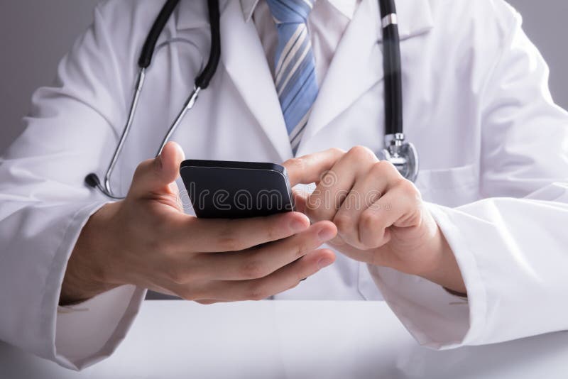 Doctor Using Smartphone in Clinic Stock Image - Image of midsection ...