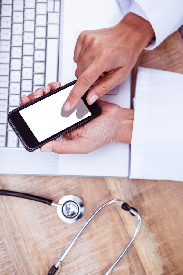 Doctor Using Smartphone on Wooden Desk Stock Image - Image of computer ...