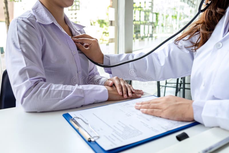 Doctor Using a Stethoscope Checking Patient about the Problem of ...