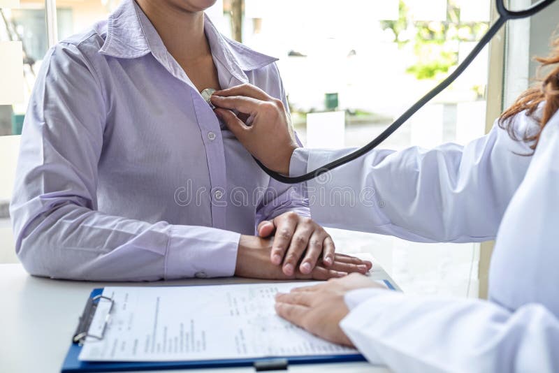 Doctor Using a Stethoscope Checking Patient about the Problem of ...