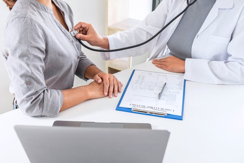 Doctor Using a Stethoscope Checking Patient about the Problem of ...