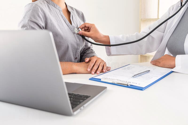 Doctor Using a Stethoscope Checking Patient about the Problem of ...