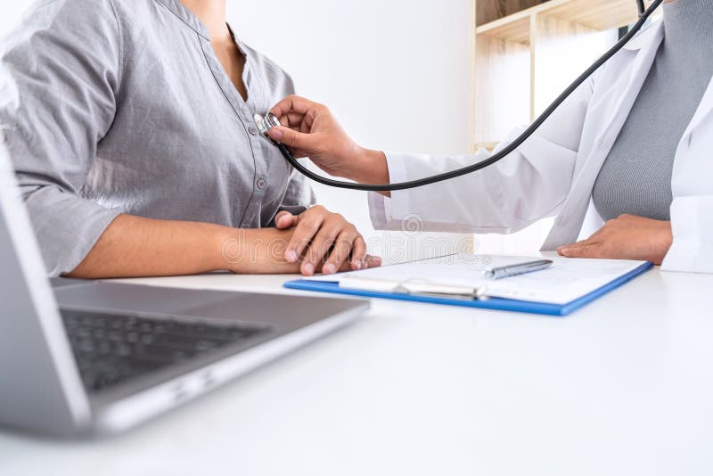 Doctor Using a Stethoscope Checking Patient about the Problem of ...